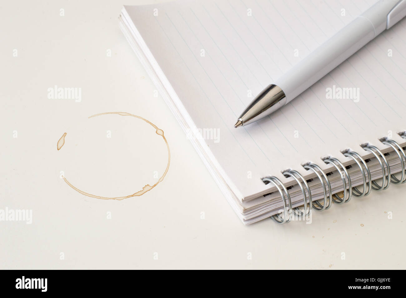 Coffee Stains and Notebook on White Background Stock Photo - Alamy