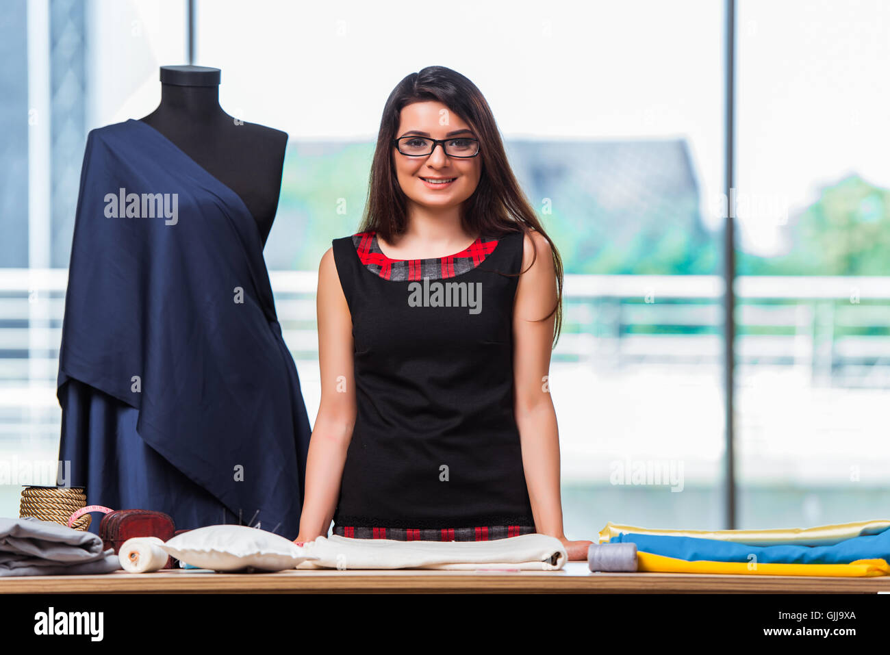 Woman tailor working on new clothing Stock Photo - Alamy