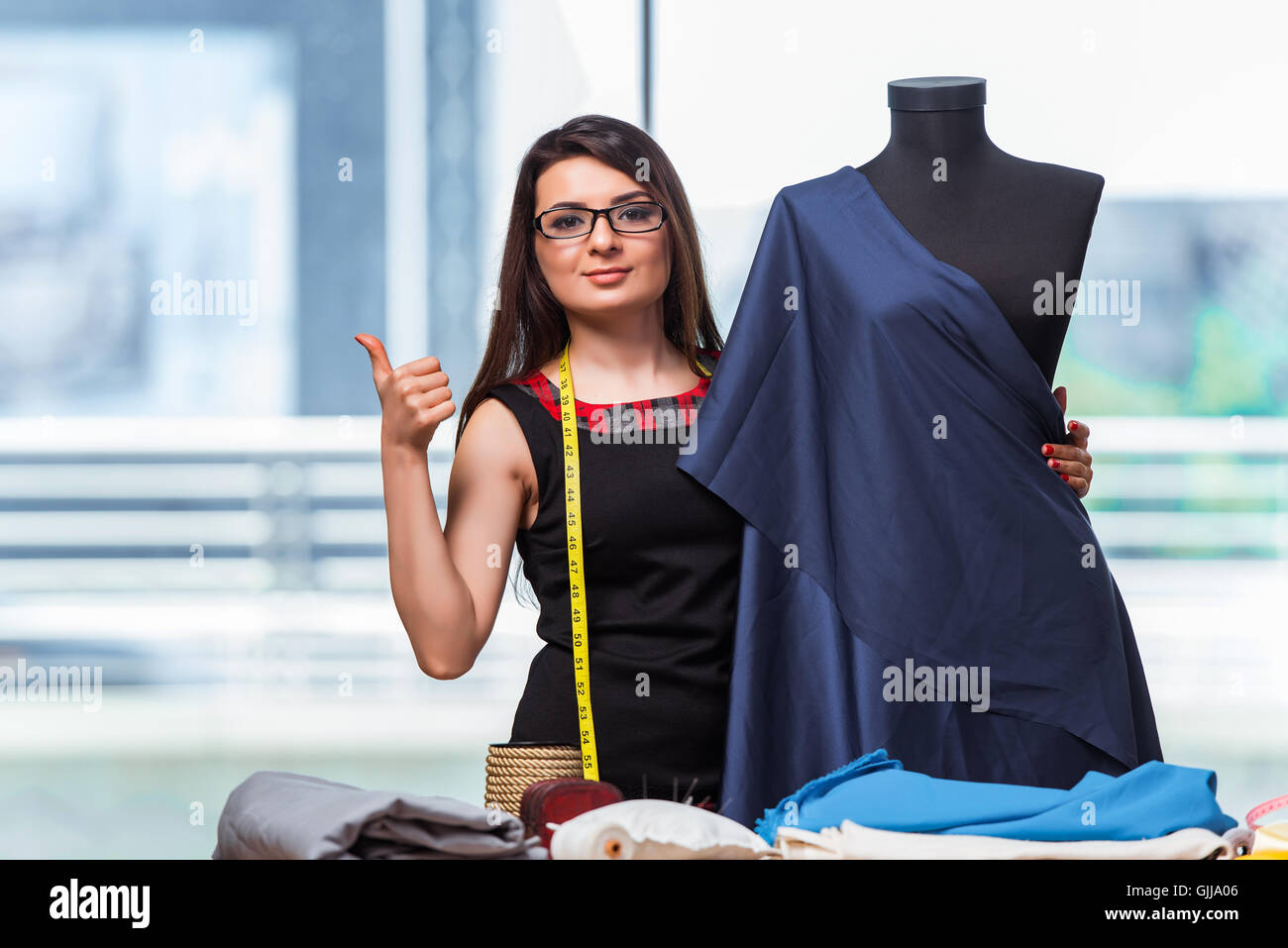 Woman tailor working on new clothing Stock Photo - Alamy