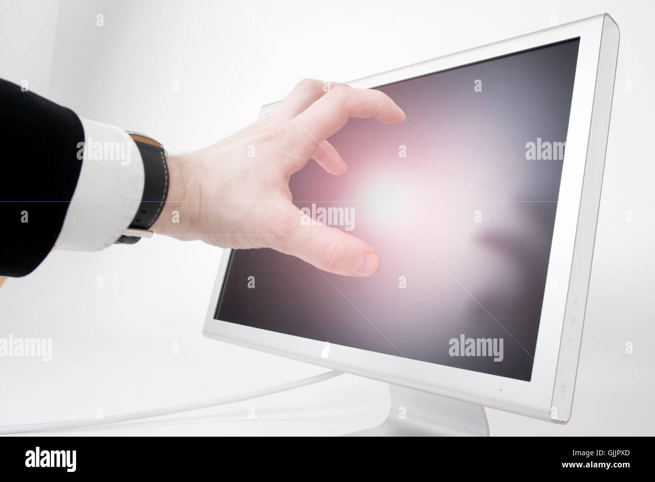 hand reaches for monitor Stock Photo - Alamy