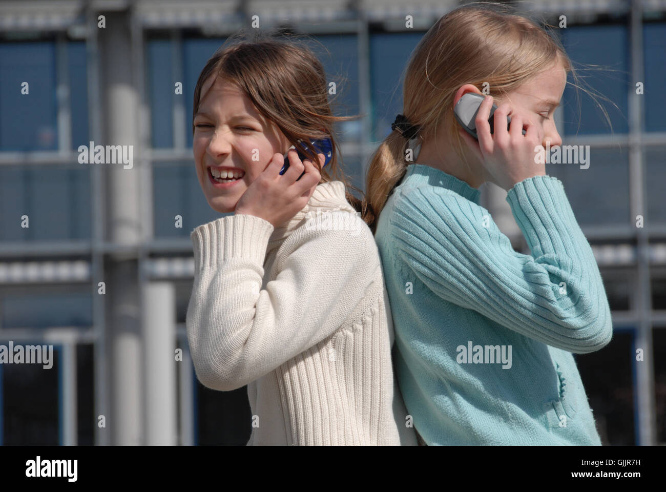 two girls on the mobile phone Stock Photo - Alamy
