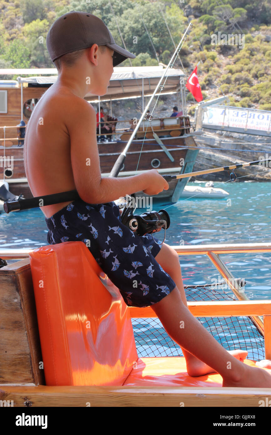 Boy relaxing in fishing boat hi-res stock photography and images - Alamy