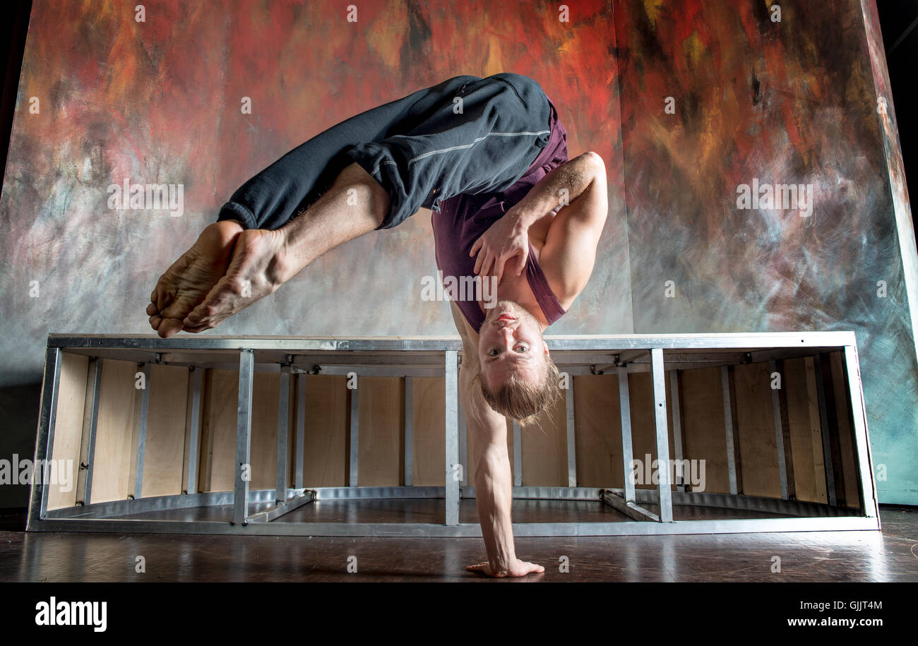 Man balancing on one hand Stock Photo - Alamy