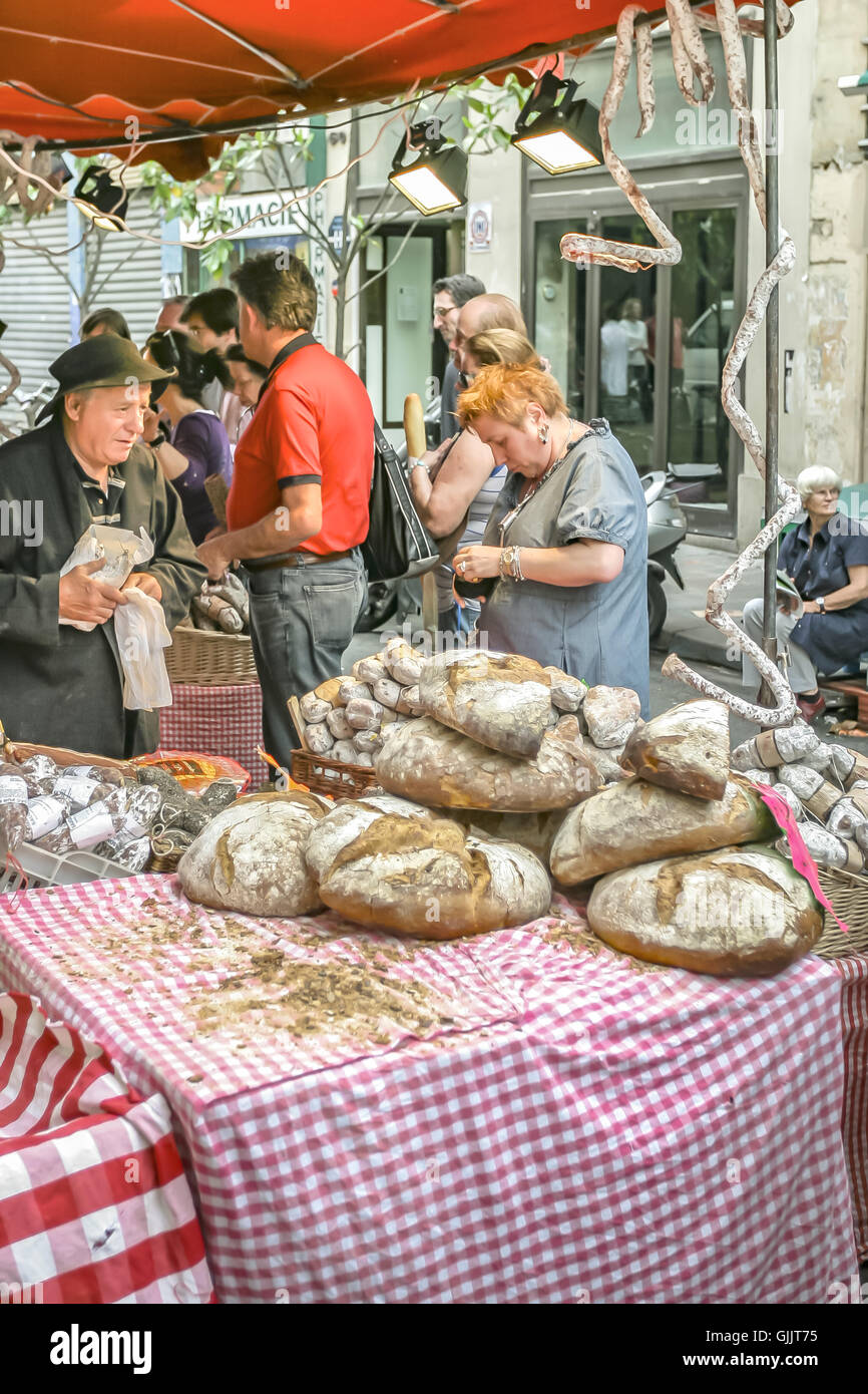 Woman buying bread at an outdoor stall in Paris, France Stock Photo - Alamy