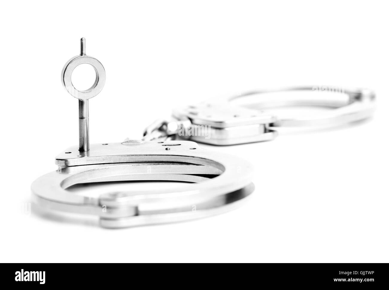 Metal handcuffs on white Black and White Stock Photos & Images - Alamy
