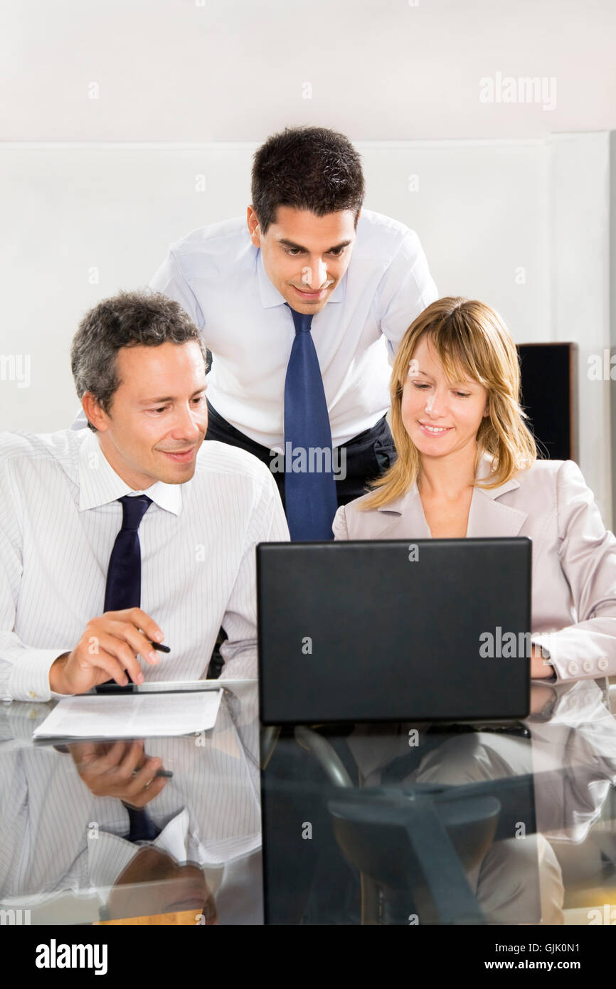 Colleagues sit using computers hi-res stock photography and images - Alamy