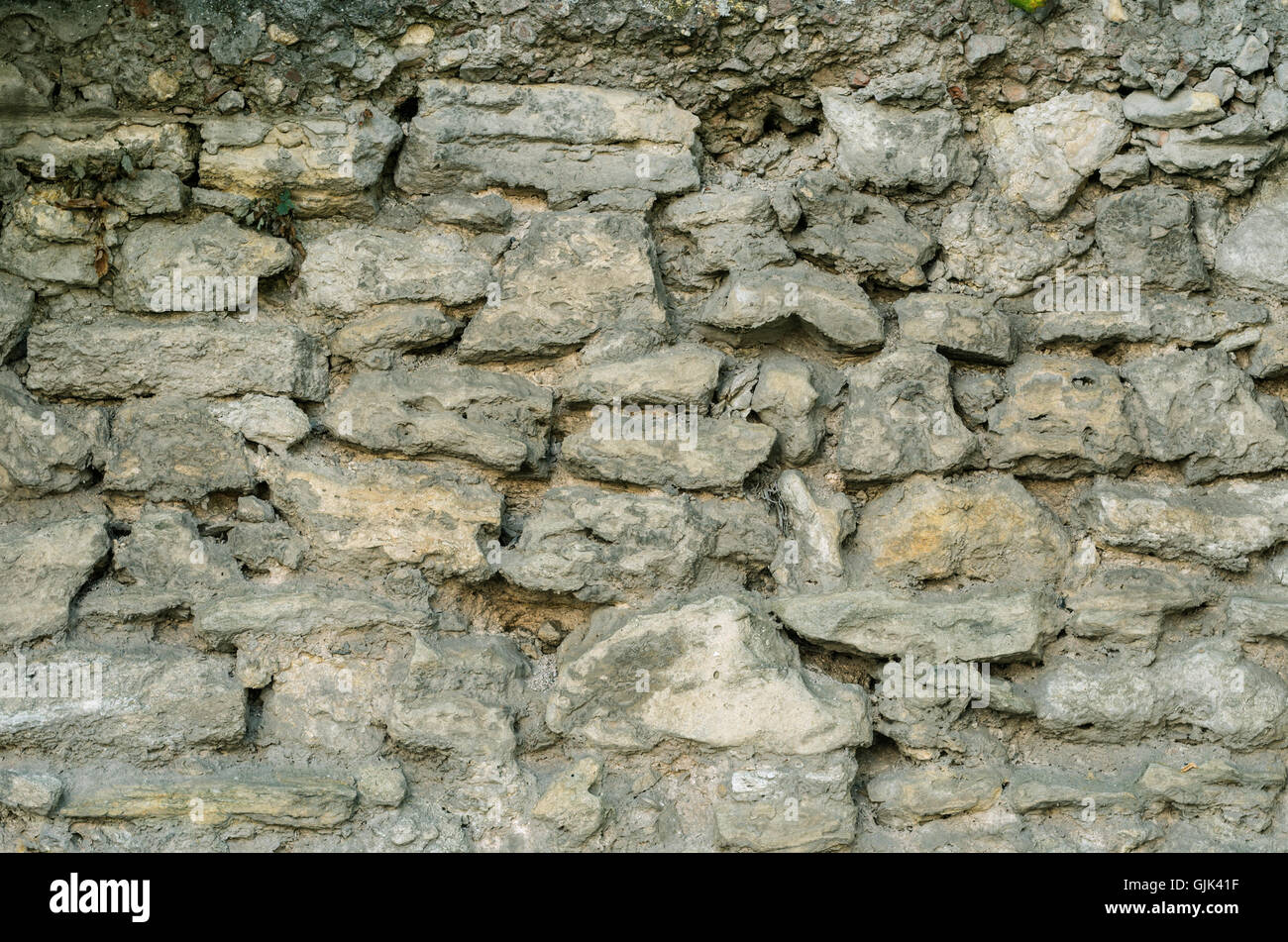 Old stone wall with signs of aging and weathering Stock Photo - Alamy