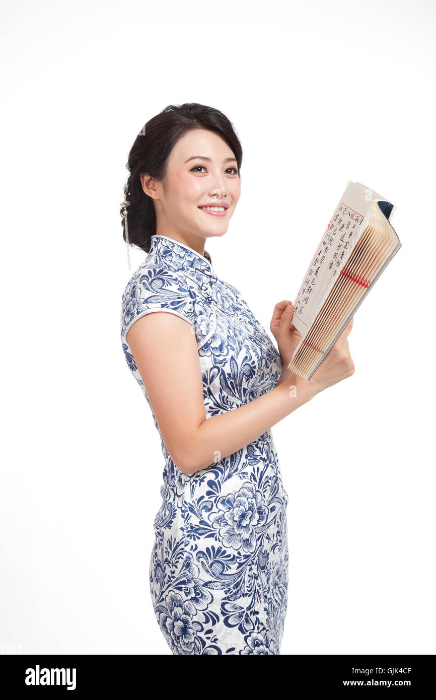 Dressed in traditional Chinese costumes studio shot young woman reading ...