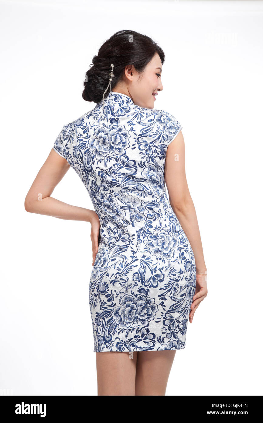 Dressed in traditional Chinese costumes studio shot young woman's back ...