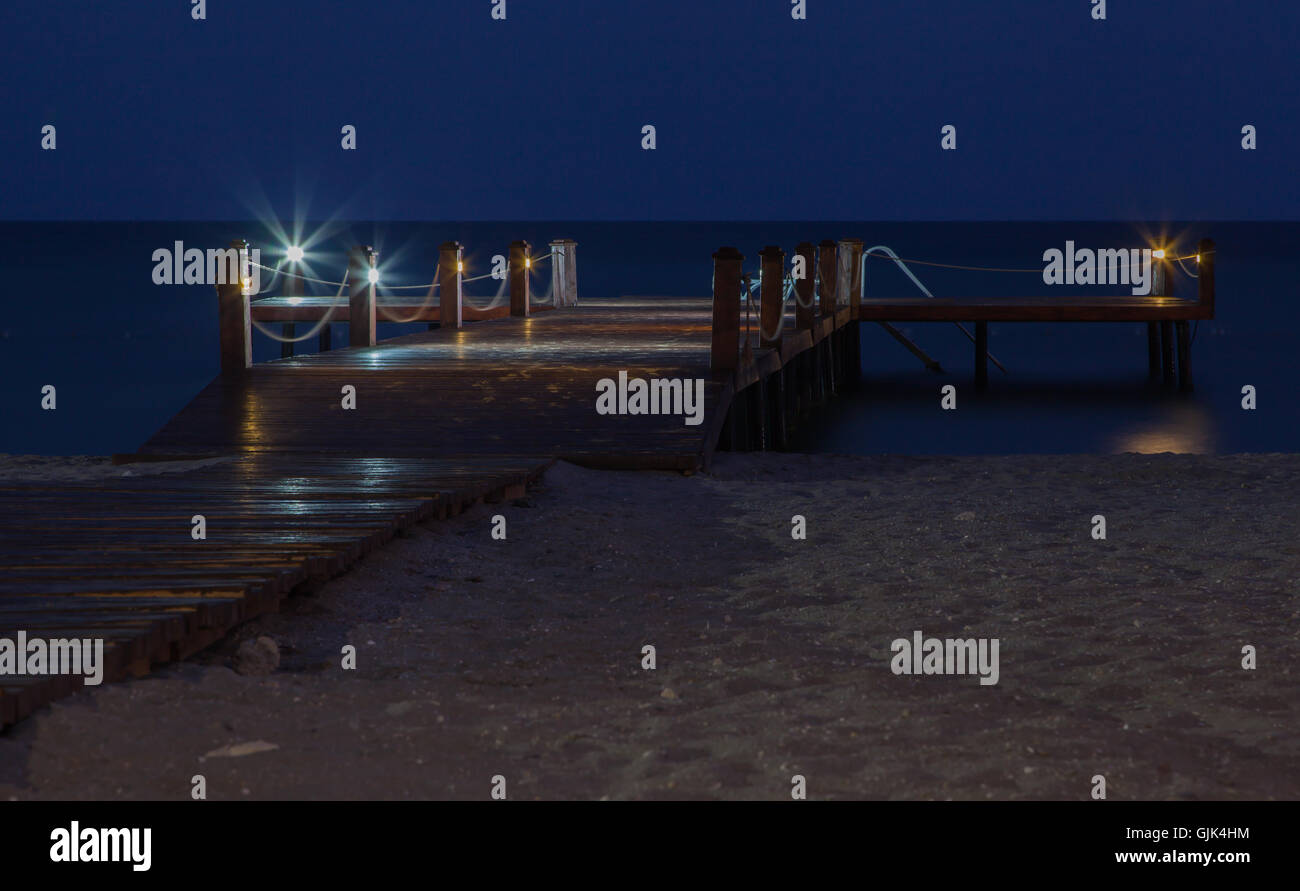 sea pier at night Stock Photo - Alamy