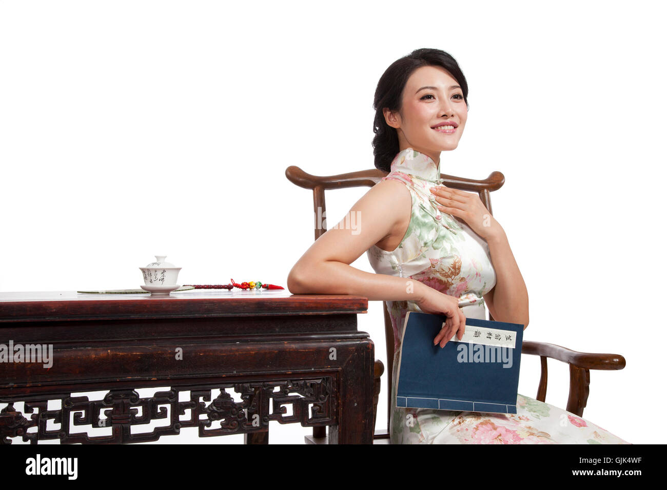 Dressed in traditional Chinese costumes studio shot young woman reading ...