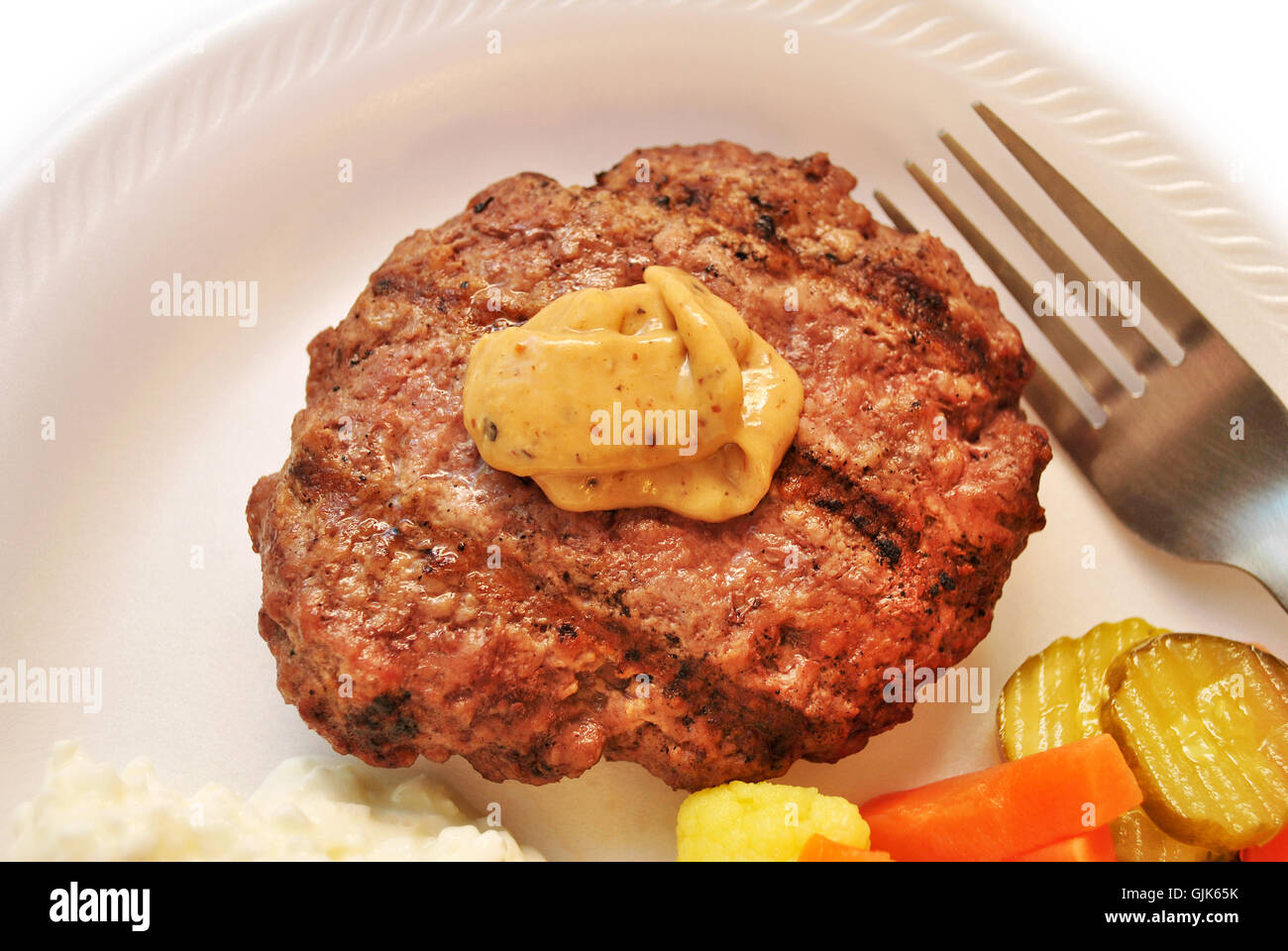 Grilled Lean Burger Topped with Spicy Mustard Stock Photo - Alamy