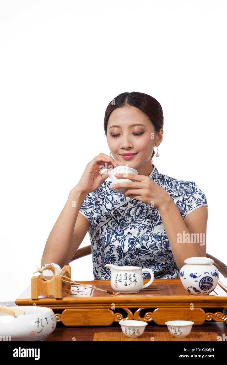 Dressed in traditional Chinese costumes studio shot young woman tea ...