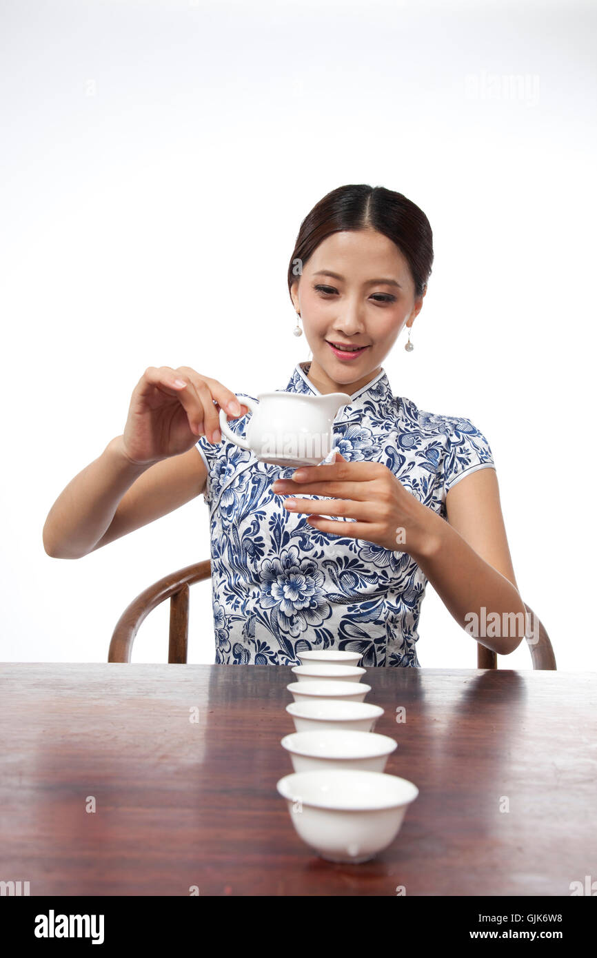 Dressed in traditional Chinese costumes studio shot young woman tea ...