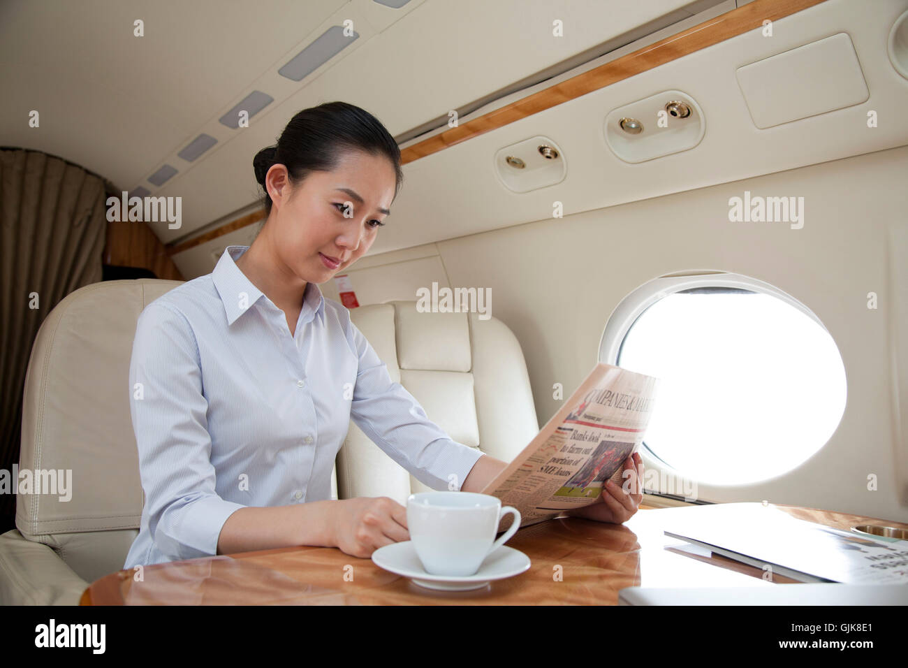 Business lady on the plane Stock Photo - Alamy