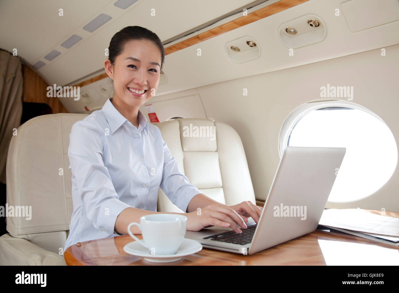 Business lady on the plane Stock Photo - Alamy