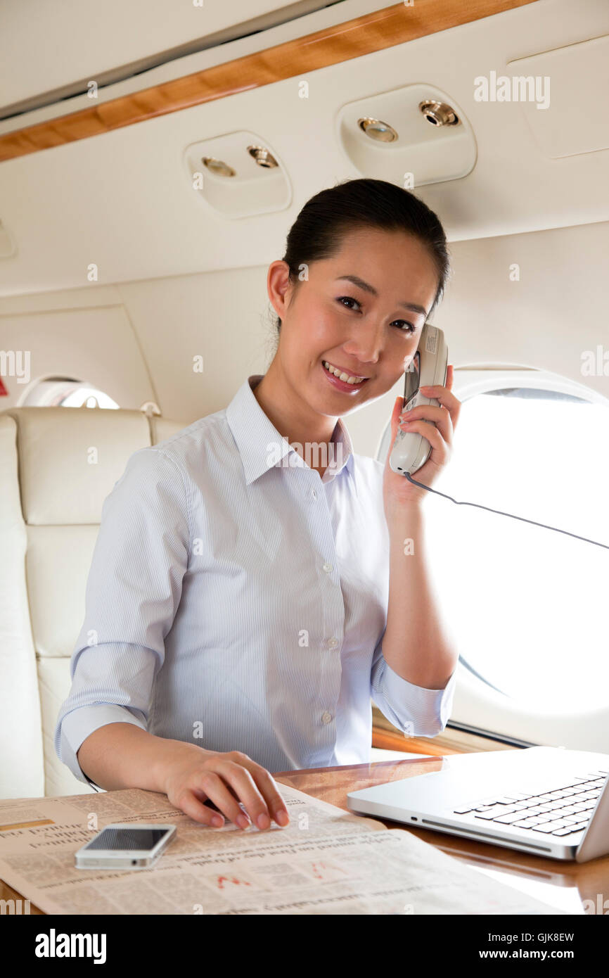 Business lady on the plane Stock Photo - Alamy
