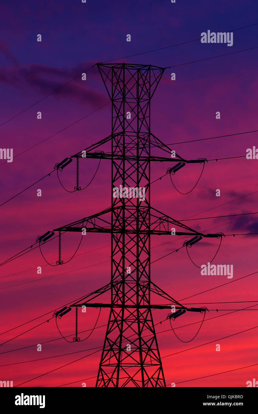 Electricity pylons in the sunset Stock Photo - Alamy