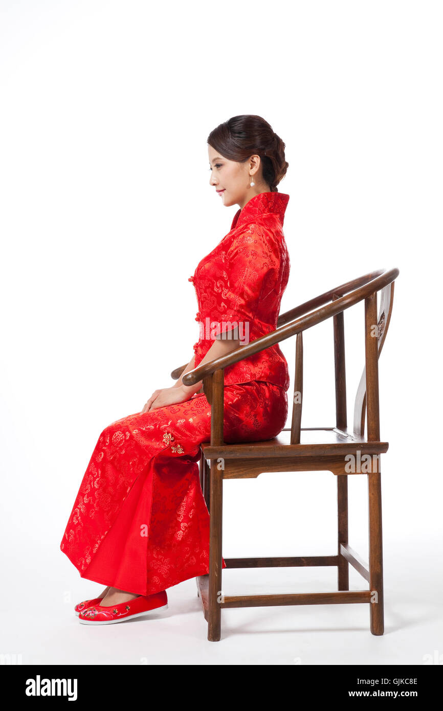 Dressed in traditional Chinese costumes studio shot young woman sitting ...