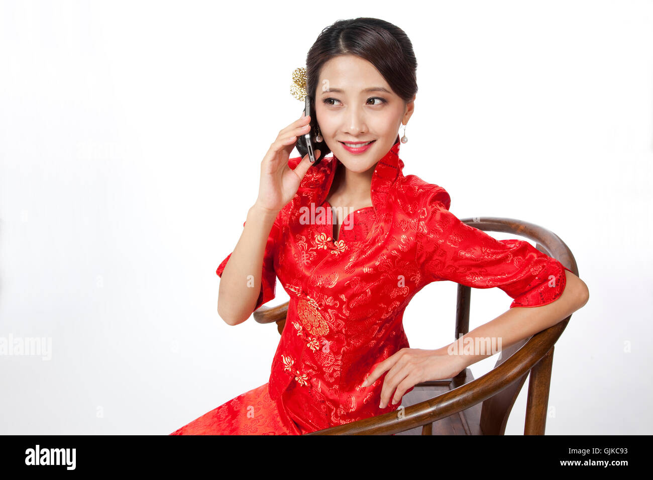 Dressed in traditional Chinese costumes studio shot young woman calling ...
