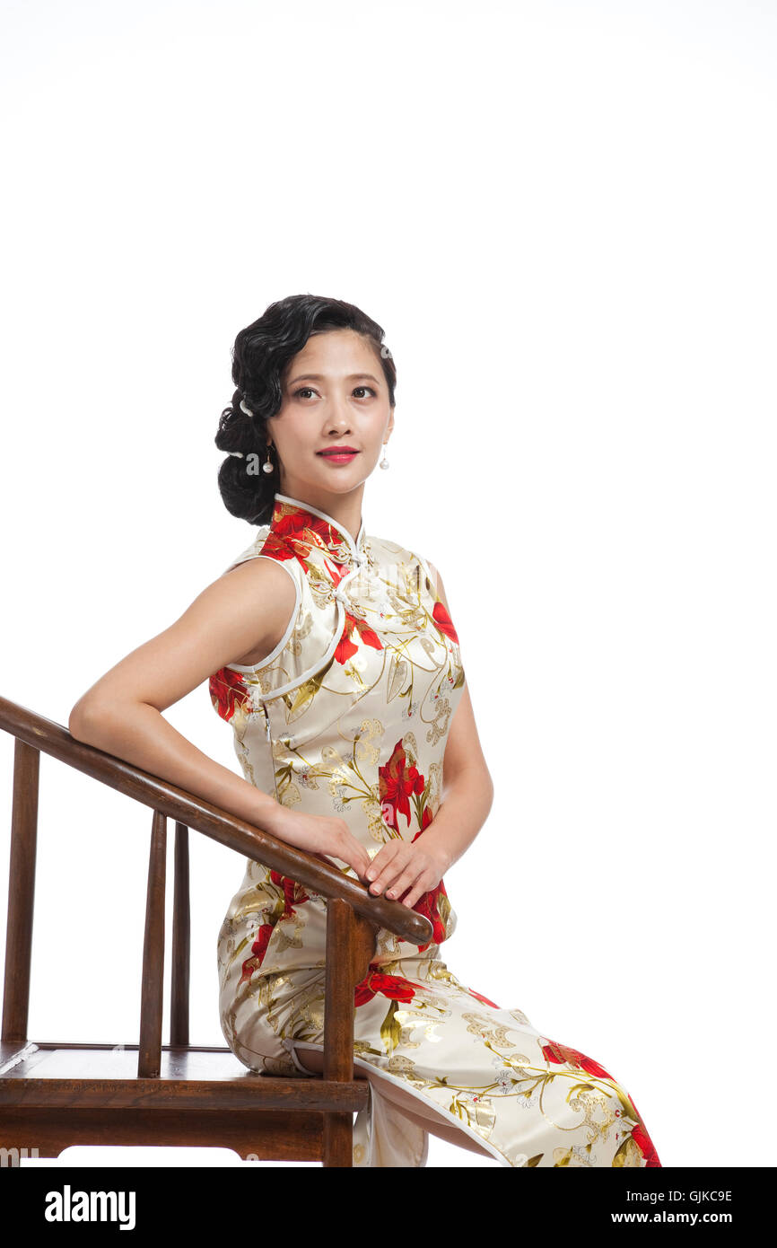 Dressed in traditional Chinese costumes studio shot young woman sitting ...