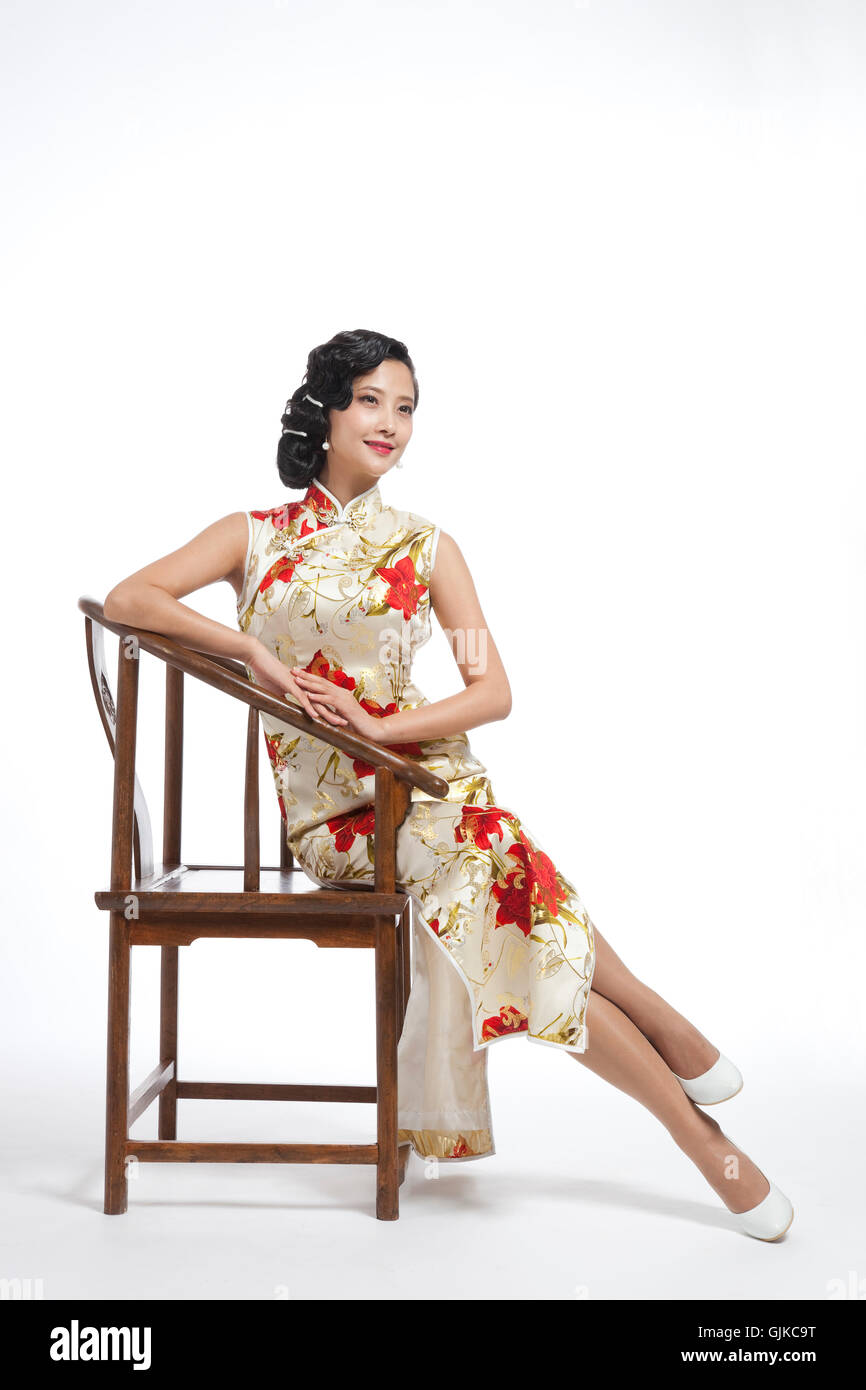 Dressed in traditional Chinese costumes studio shot young woman sitting ...