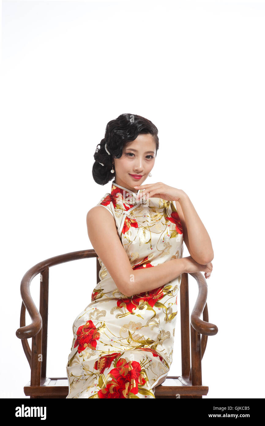 Dressed in traditional Chinese costumes studio shot young woman sitting ...
