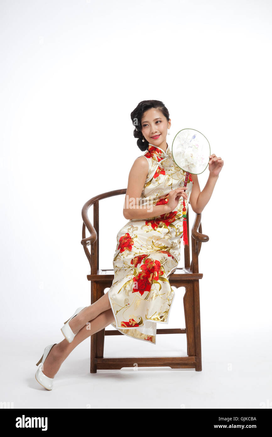 Dressed in traditional Chinese costumes studio shot young woman sitting ...
