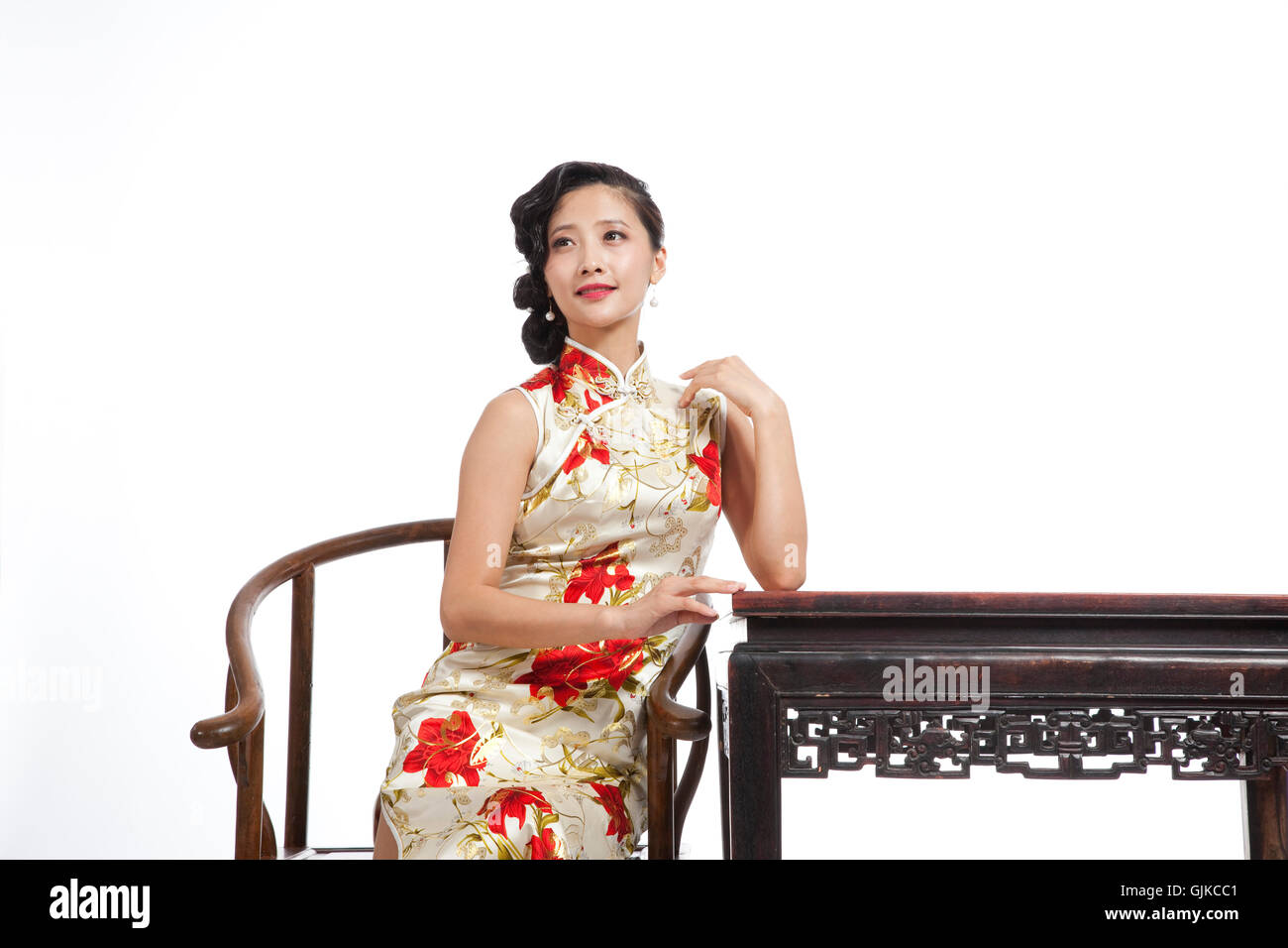 Dressed in traditional Chinese costumes studio shot young woman sitting ...