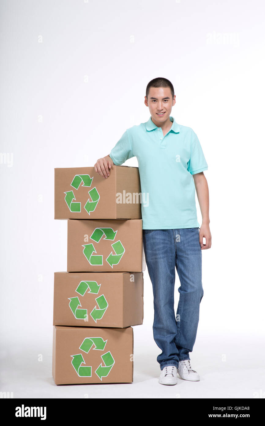 Studio shot Young casual man and carton Stock Photo - Alamy