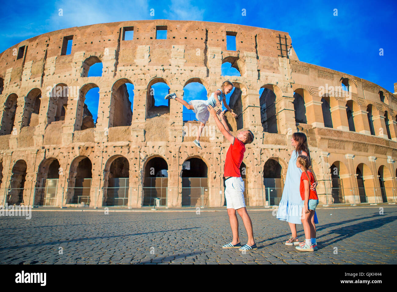 Happy family in Europe. Parents and kids in Rome over Coliseum ...