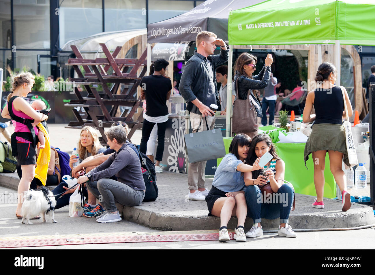 a motley crowd of East London drinking a beer outside of pub Stock ...