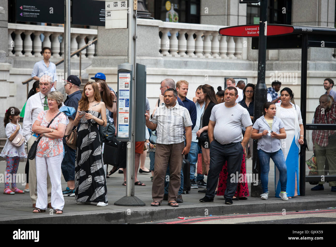 People waiting at a bus stop in London UK Stock Photo - Alamy