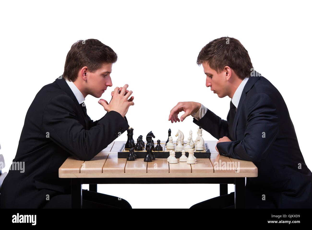 Twin brothers playing chess isolated on white Stock Photo - Alamy