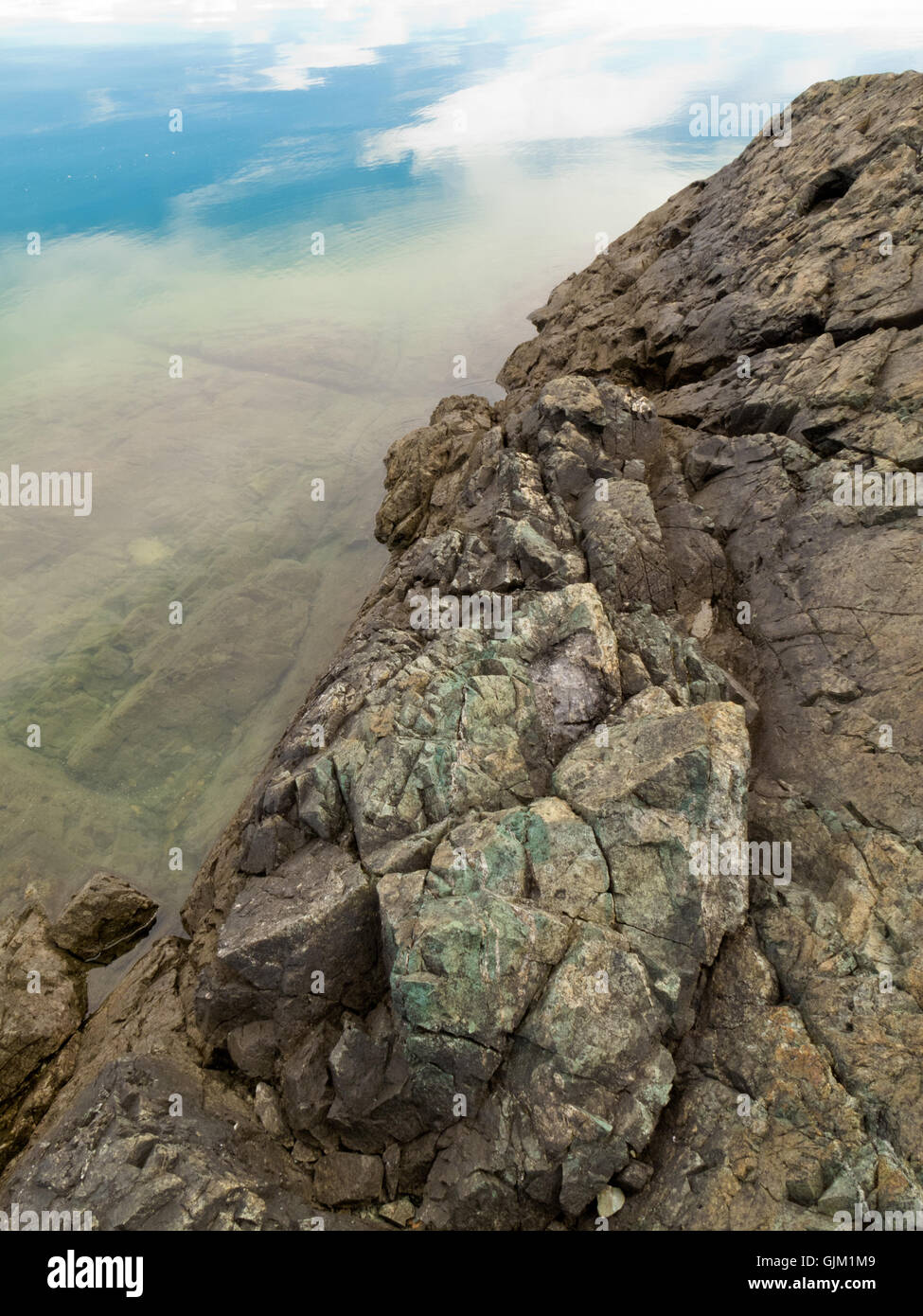 Mineral rich geologic formation at waters edge Stock Photo - Alamy