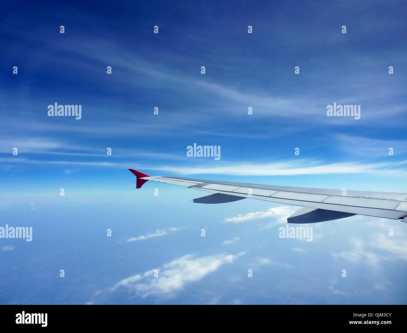 Wing of a plane flying in the sky Stock Photo - Alamy