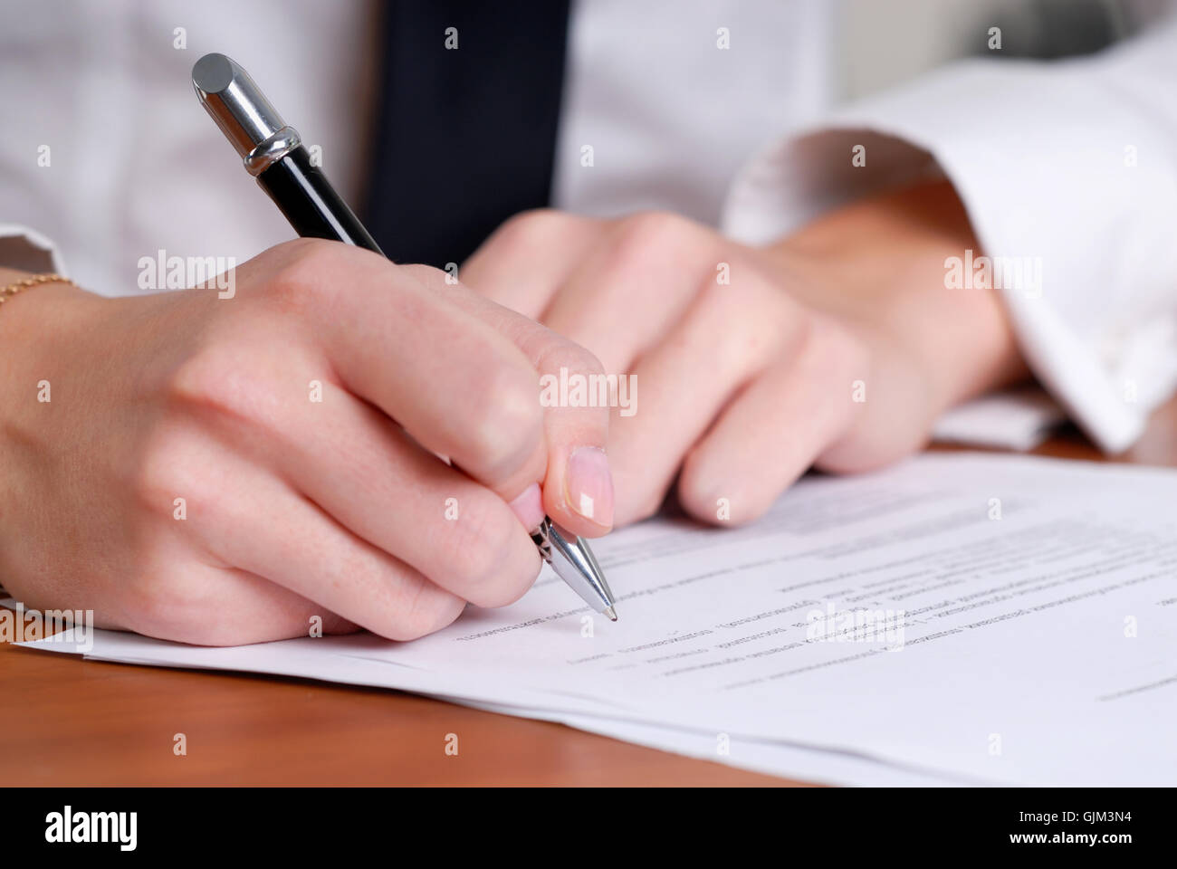 person's hand signing an important document Stock Photo - Alamy