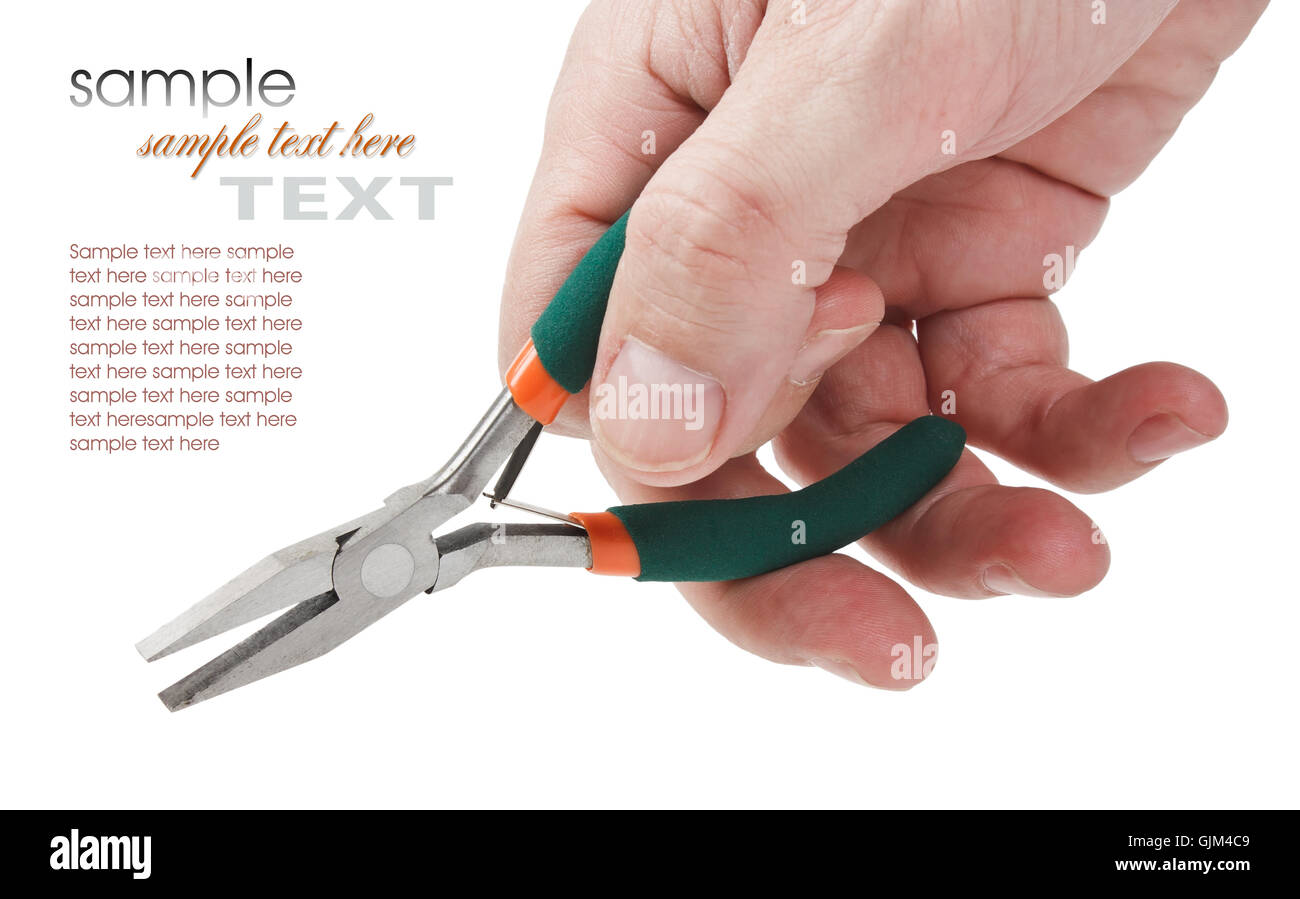 Pliers in hand Stock Photo - Alamy