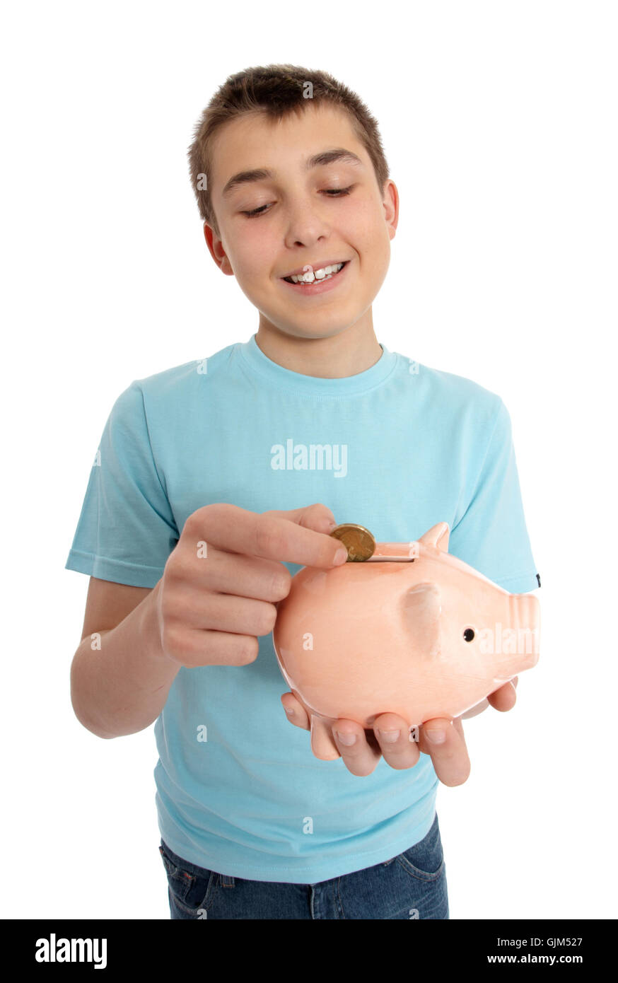 Boy dropping coin into money box Stock Photo - Alamy