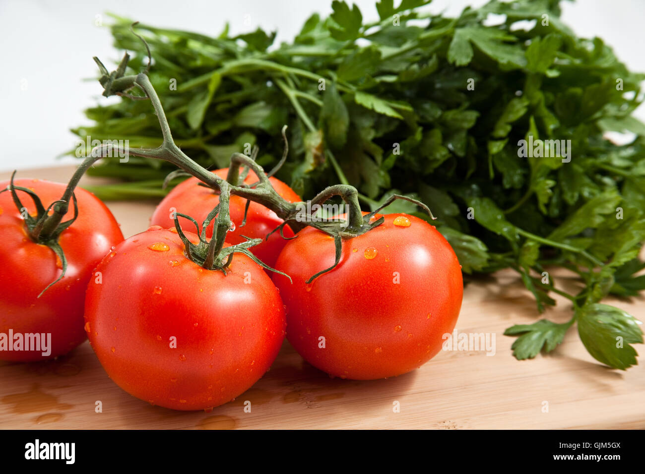 Tomato with parsely Stock Photo - Alamy