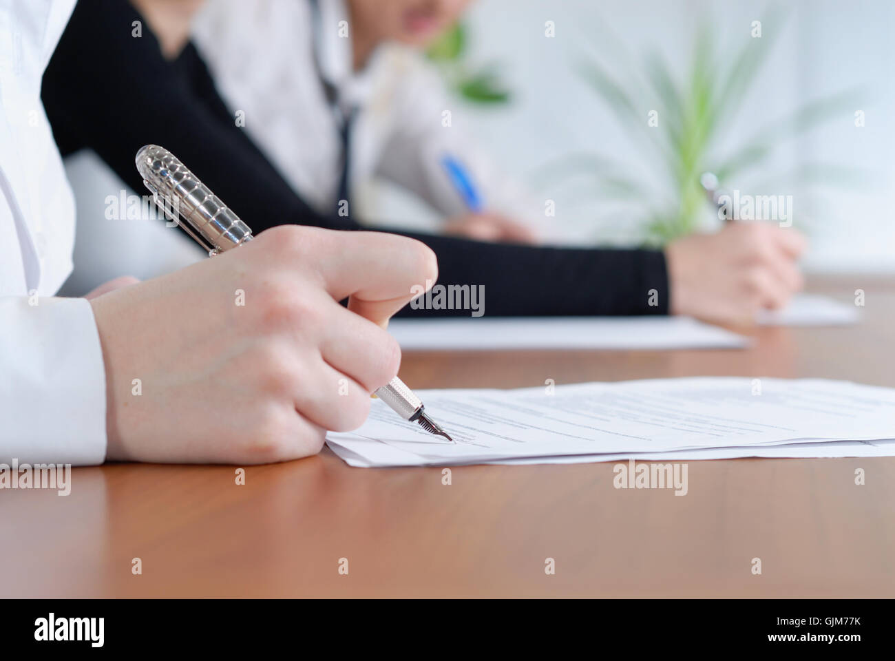 person's hand signing an important document Stock Photo - Alamy