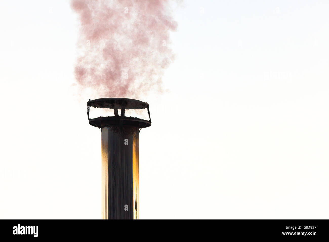 Smoking residential chimney Stock Photo - Alamy