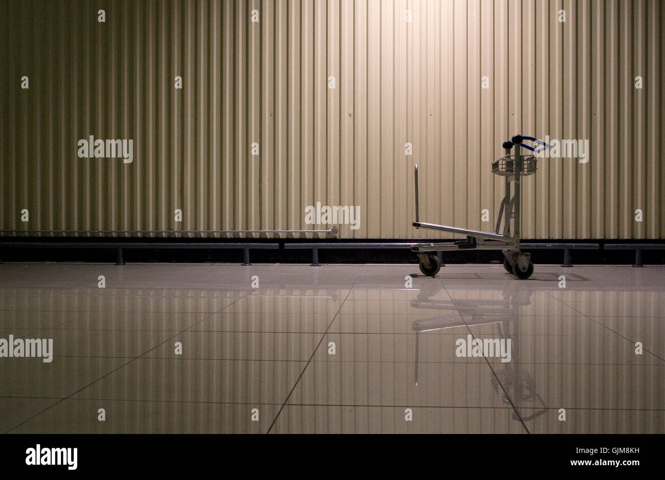 Trolley in empty warehouse Stock Photo - Alamy