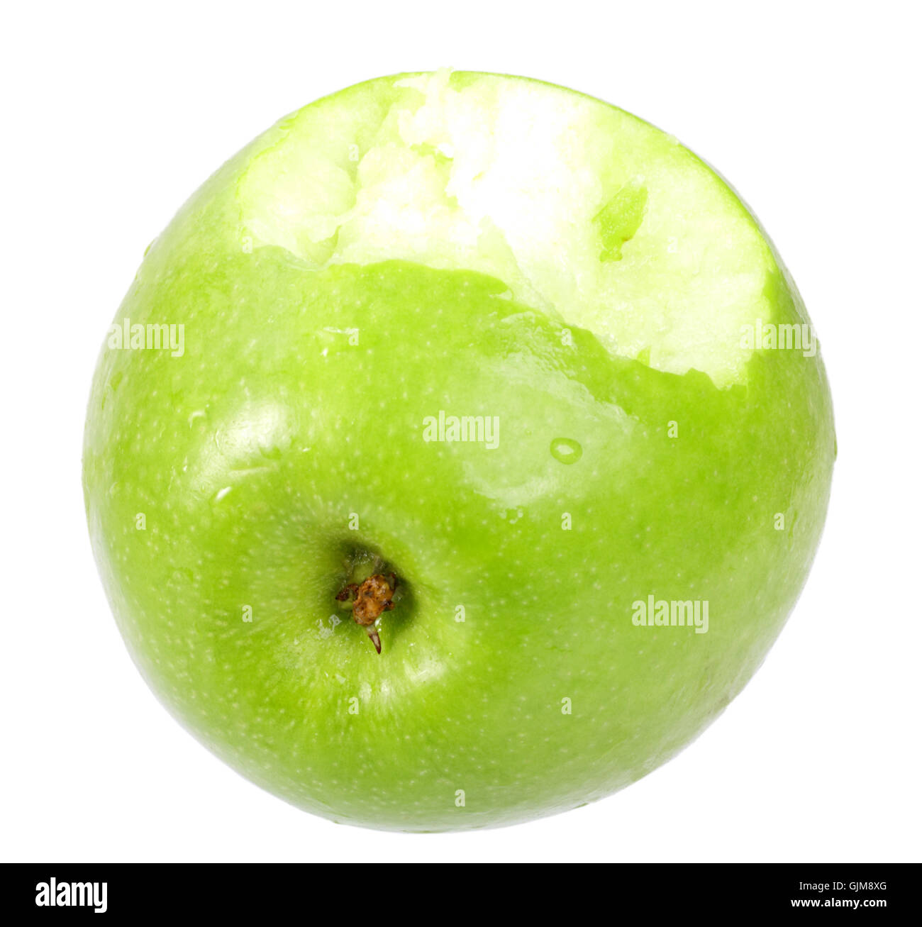 Single a green apple with bite Stock Photo - Alamy