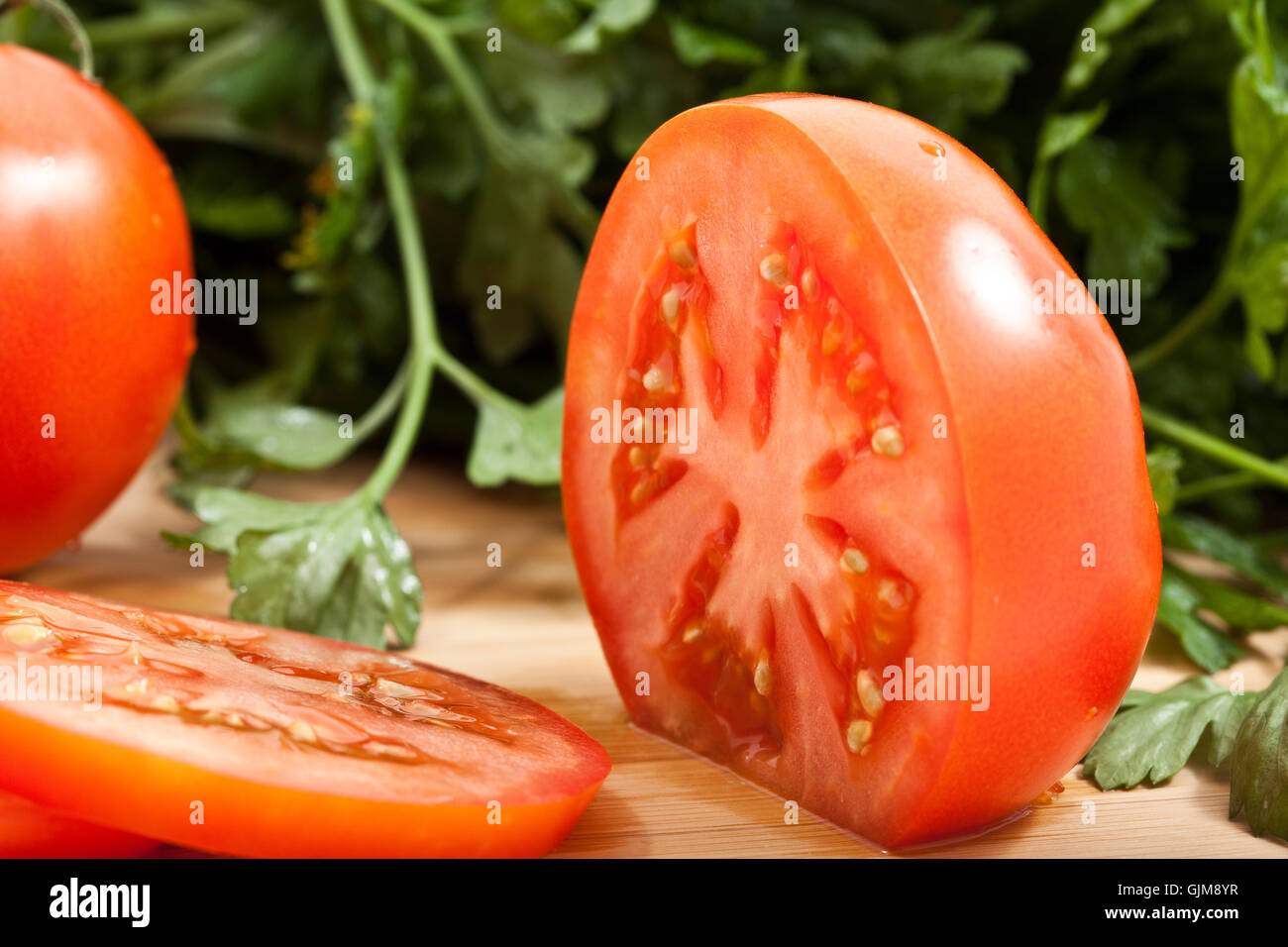 Tomato with parsely Stock Photo - Alamy