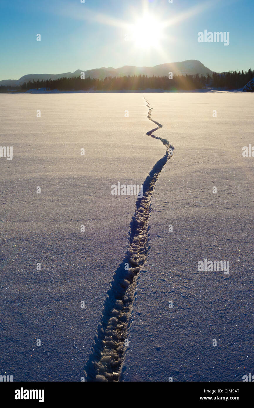 Wide crack in snow and ice surface Stock Photo - Alamy