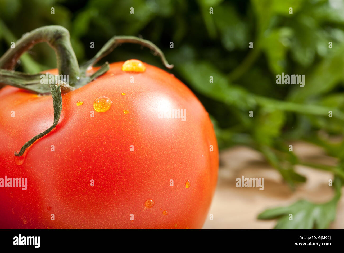 Tomato with parsely Stock Photo - Alamy