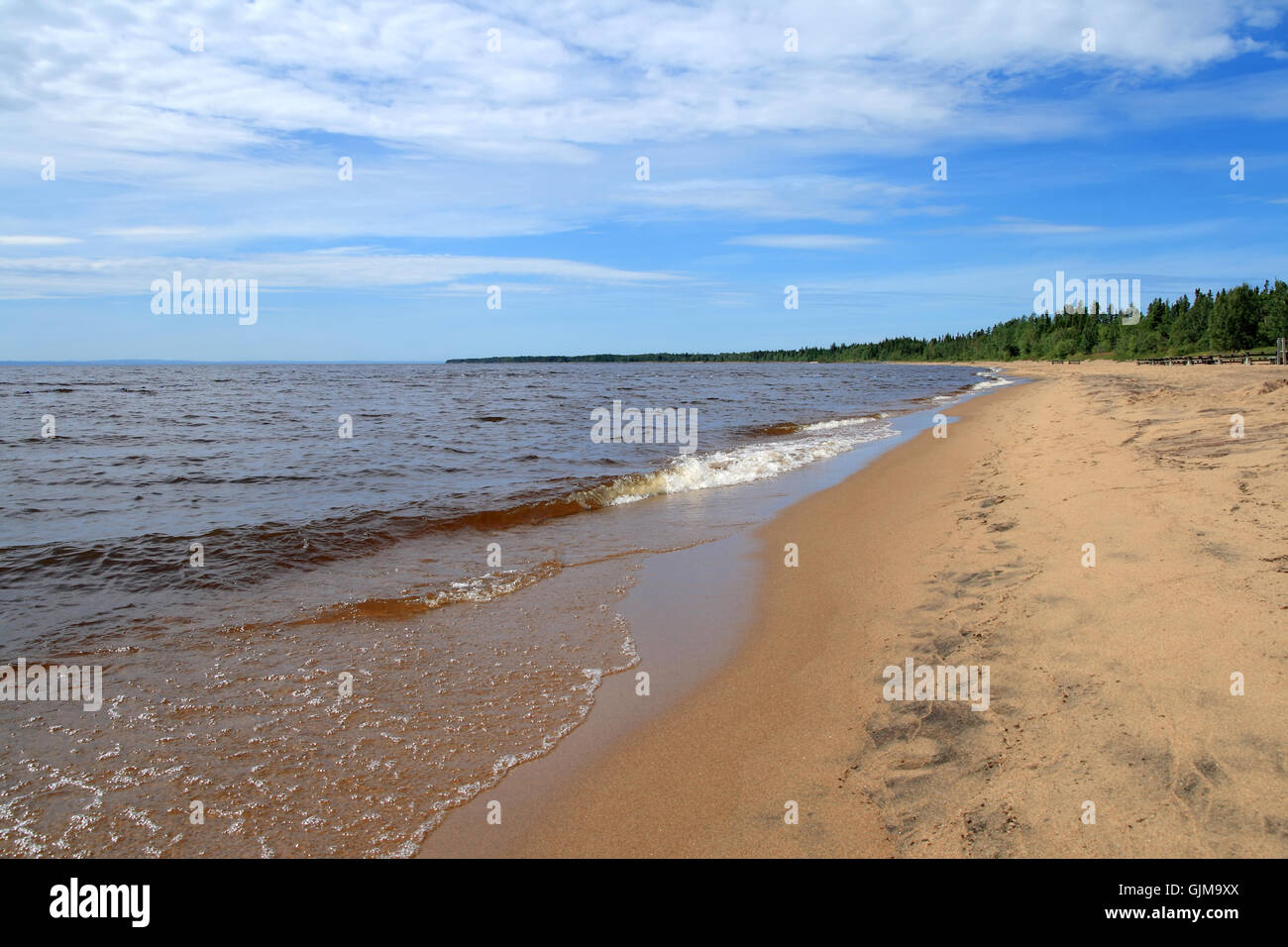 Waves running over sand beach Stock Photo - Alamy