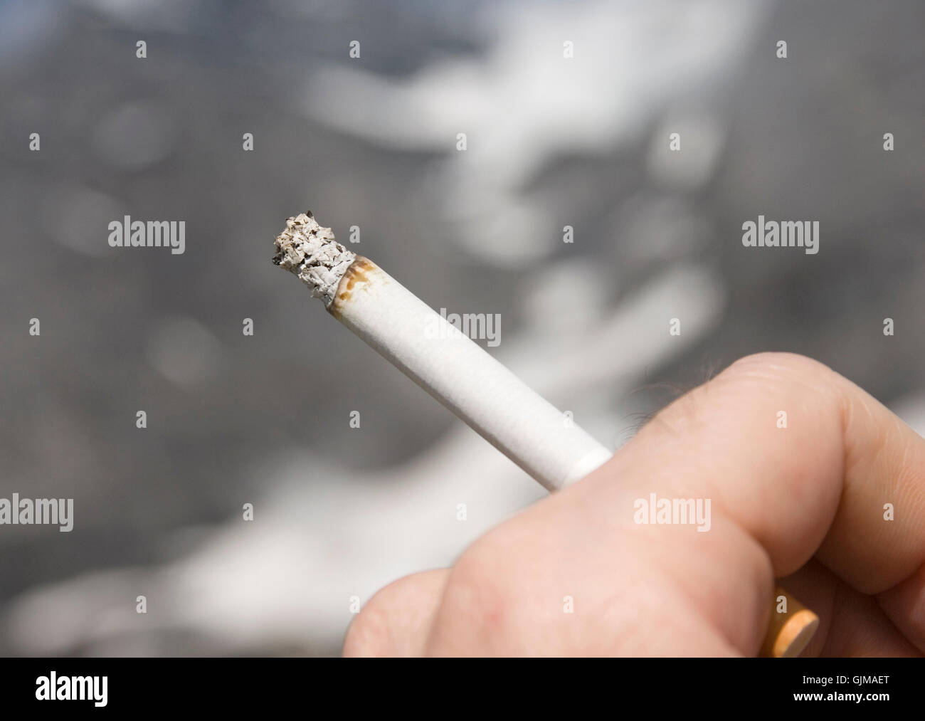 cigarette hand closeup Stock Photo - Alamy