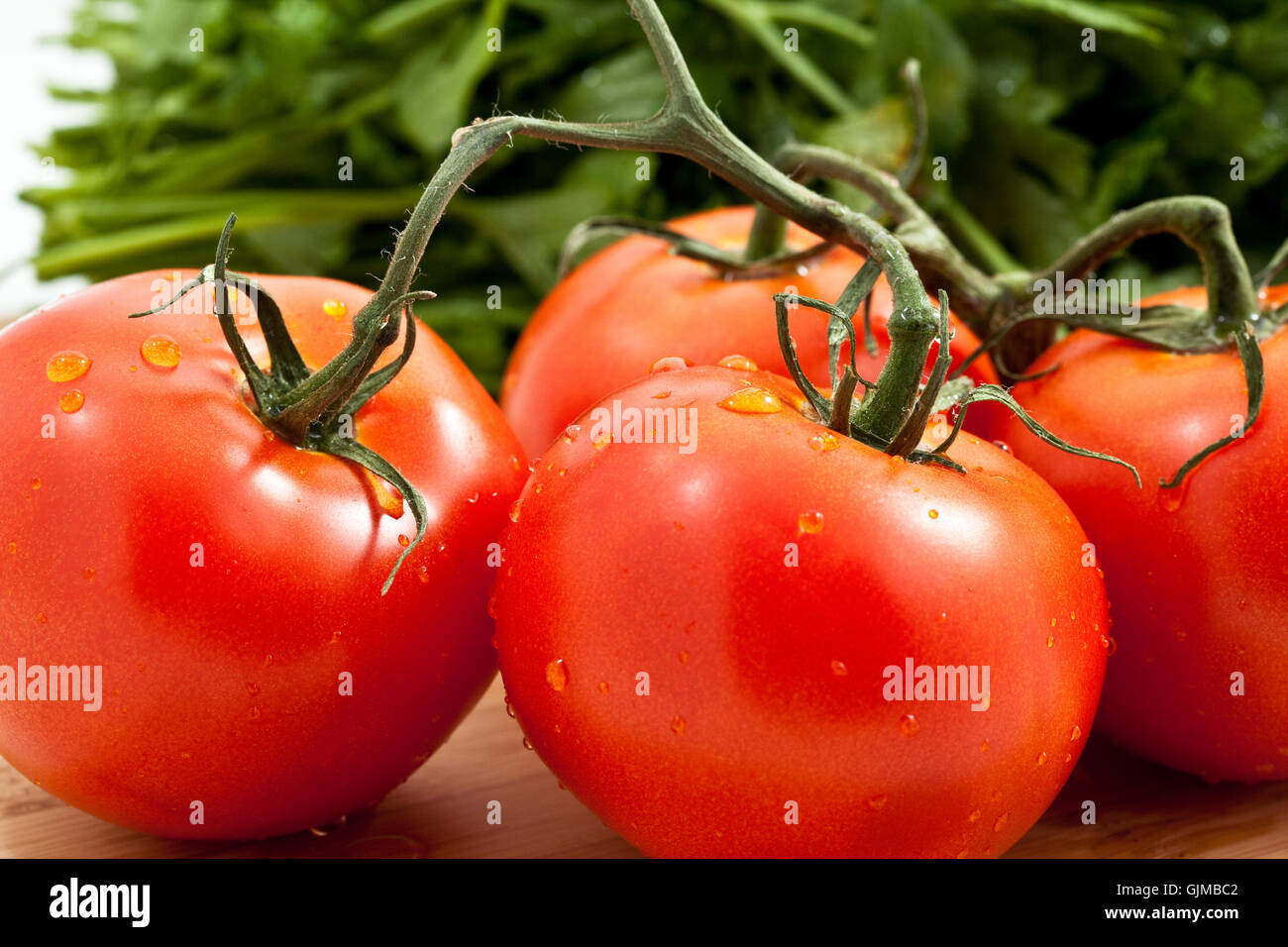 Tomato with parsely Stock Photo - Alamy